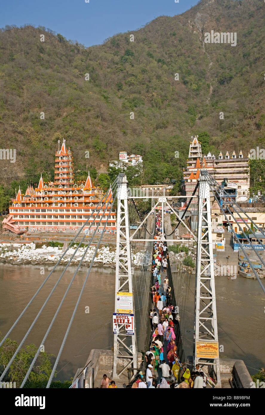 Pedestrinas crossing Lakshman Jhula suspension bridge over Ganges river ...