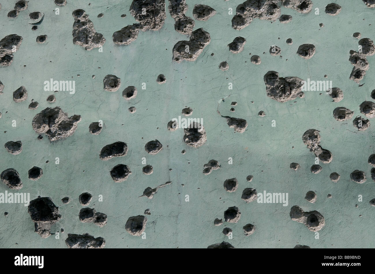 A wall shows shrapnel damage or bullet-holes from the 1992-95 war in ...