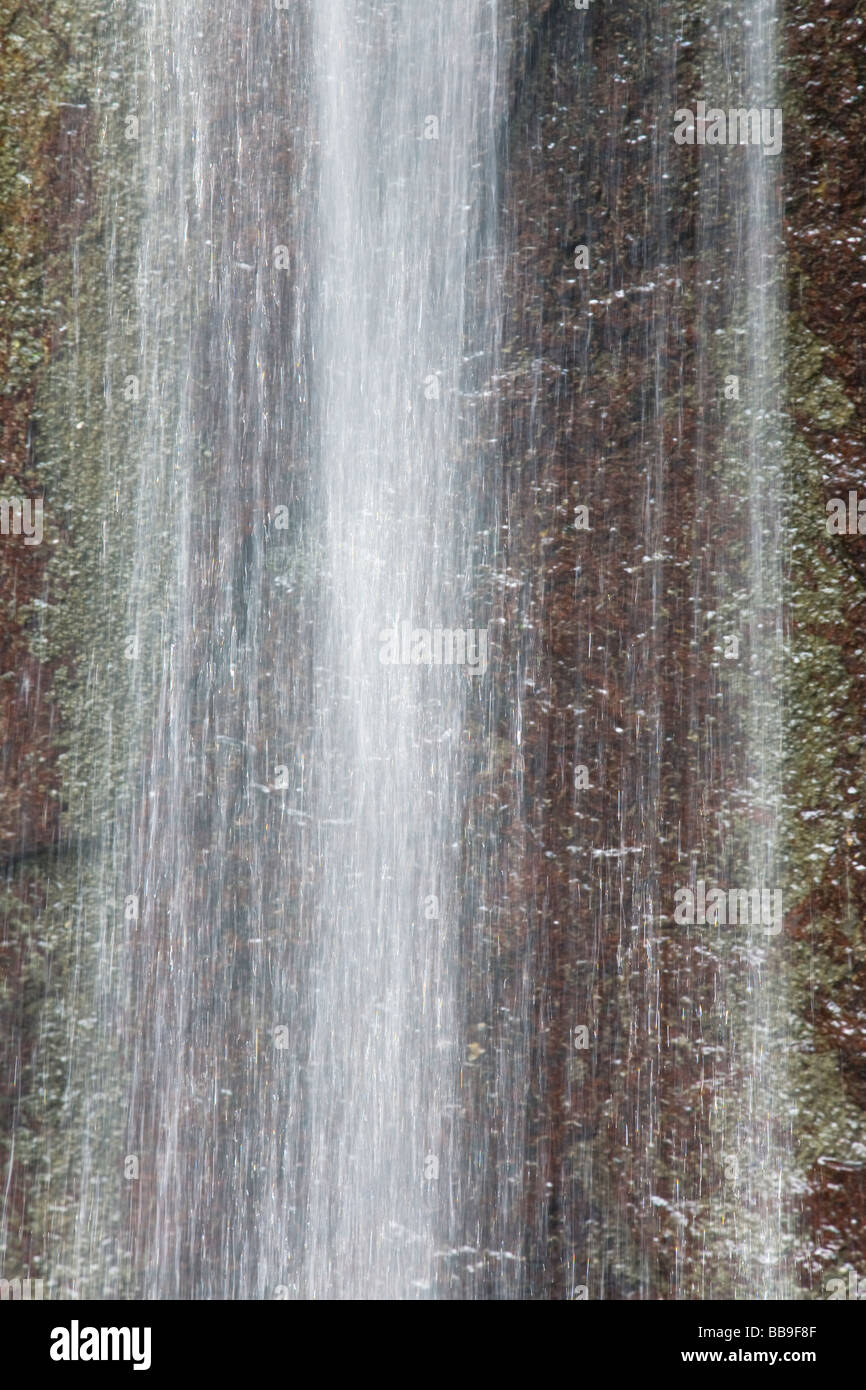 Small spring mountain waterfall and rock behind Stock Photo - Alamy