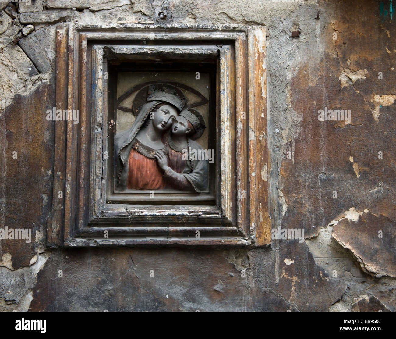 Crumbling religious devotional shrine of the Madonna & child in the ...