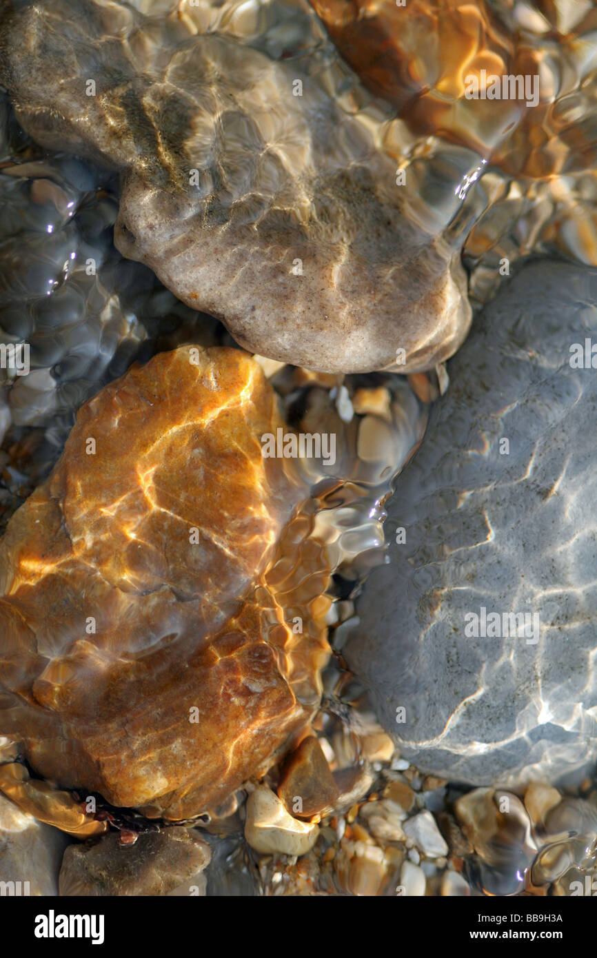 pebbles in a rockpool on the beach Stock Photo - Alamy