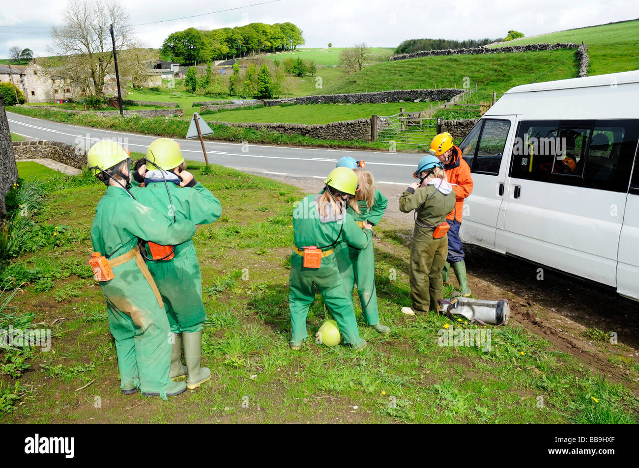 Group of school children preparing to go caving in the Peak District ...