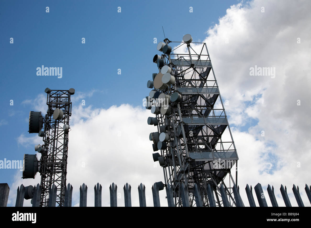 Communication towers behind a fence in England, UK Stock Photo - Alamy