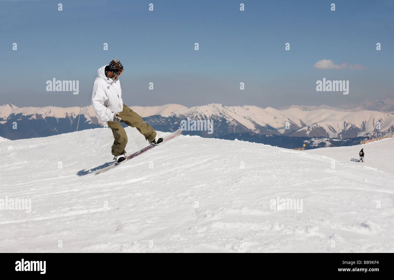 Winter Sports;Snow Boarder;Male about to go over the crest of a snow ...