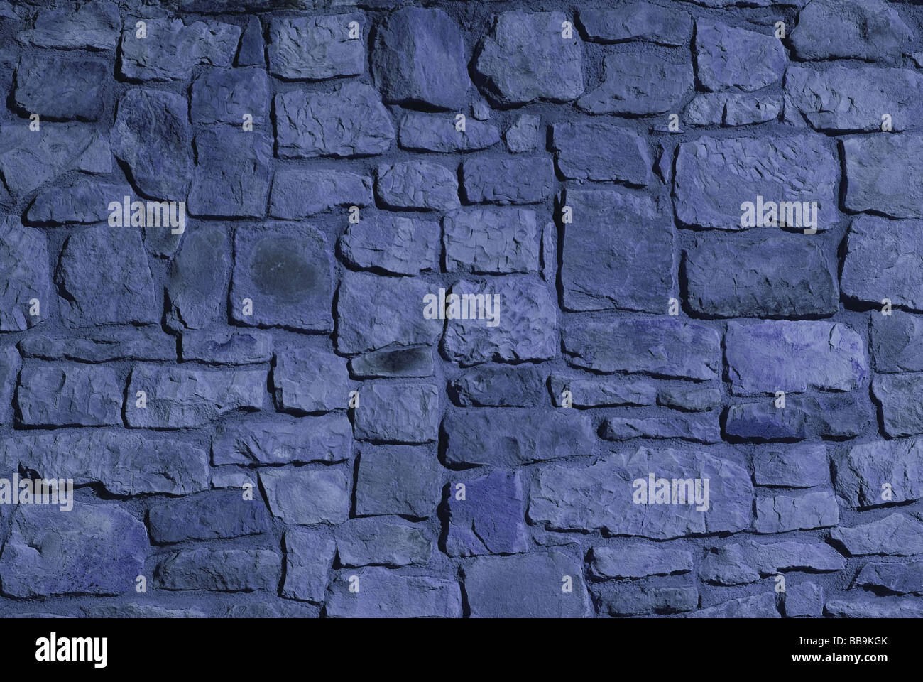 Stone wall. Artificial blue light Stock Photo - Alamy