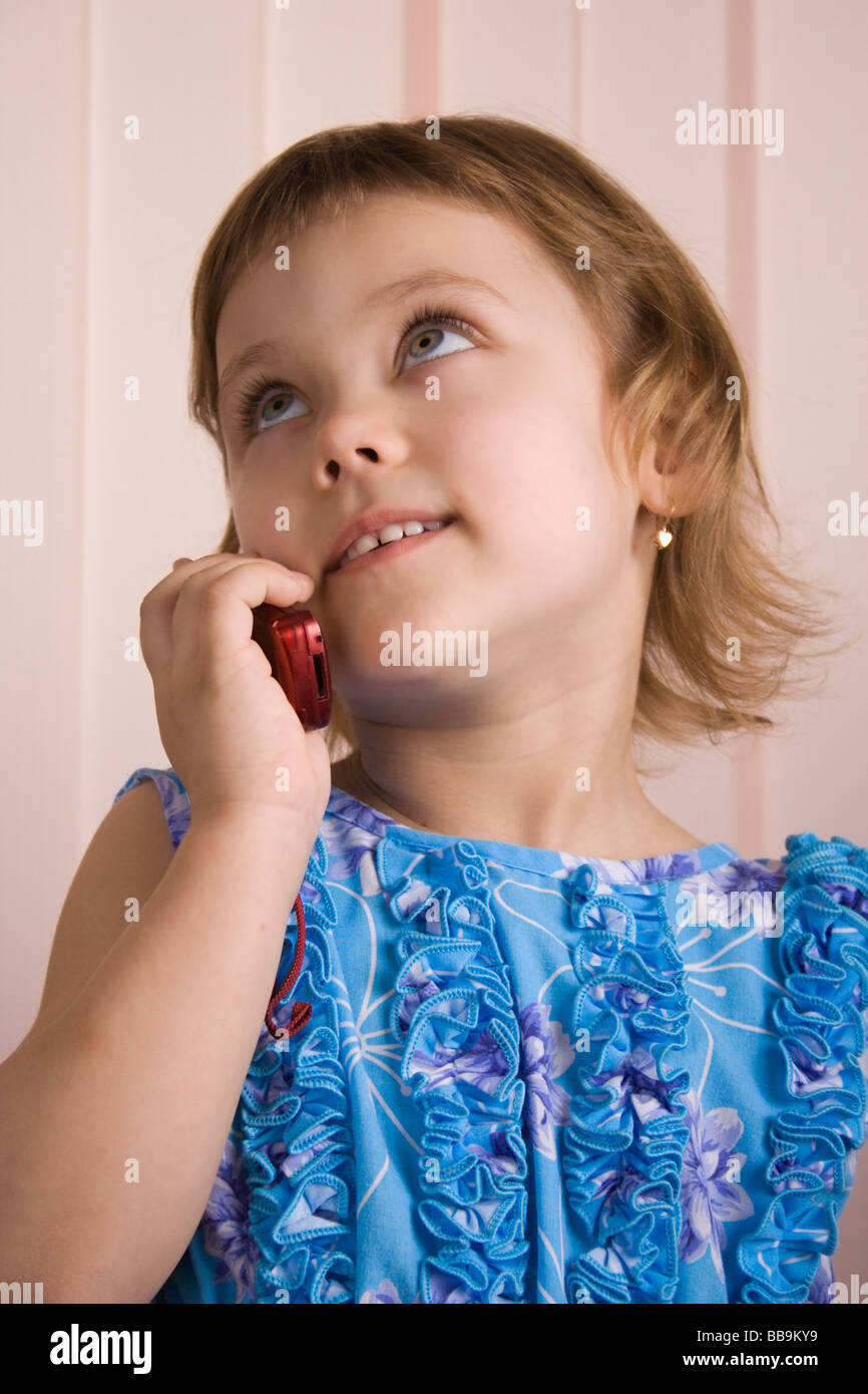 Pretty smiling girl talking at mobile phone Stock Photo - Alamy