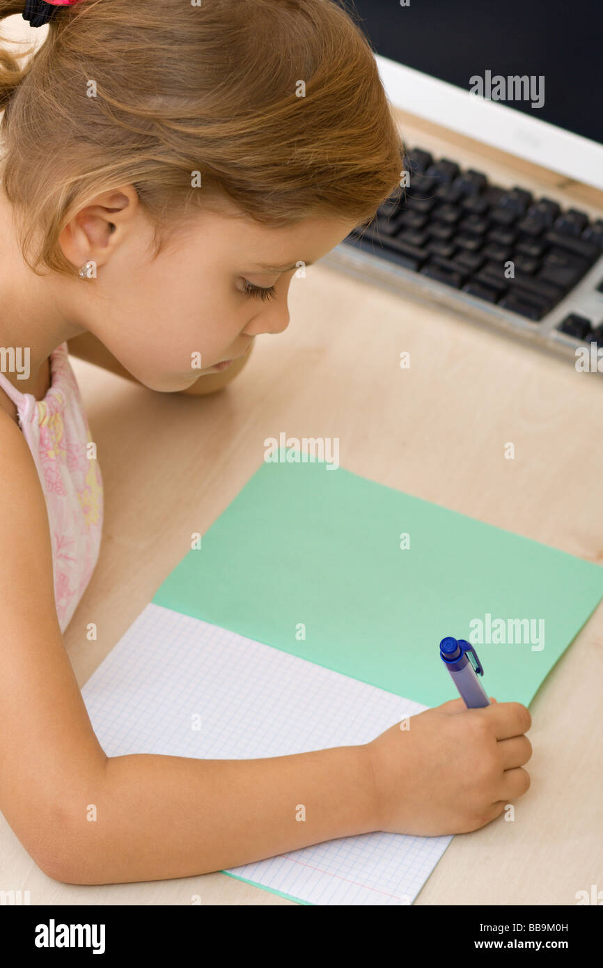 Young serious girl writing in a notebook Stock Photo - Alamy