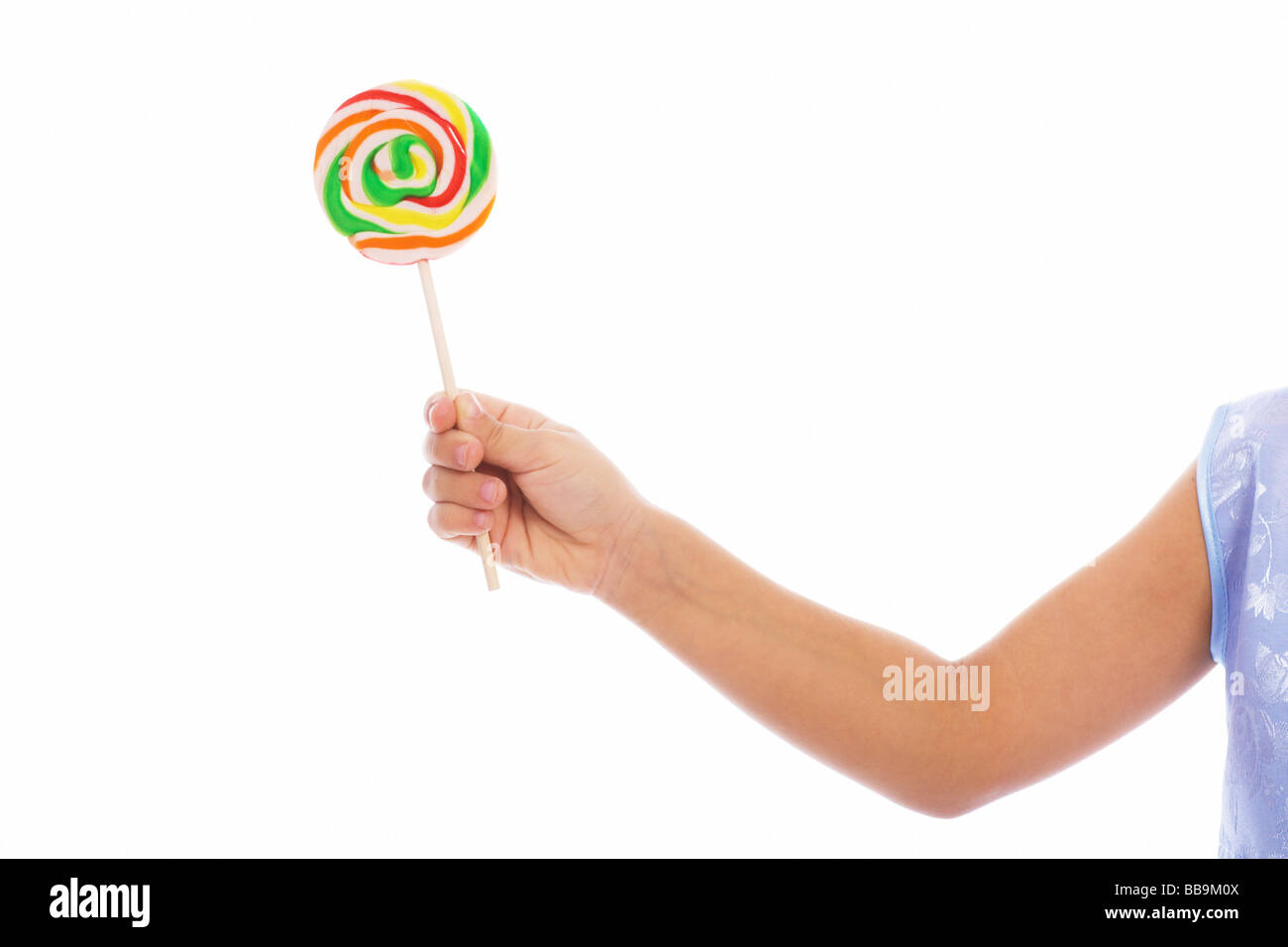 Color lollipop in child hand isolated on white Stock Photo - Alamy