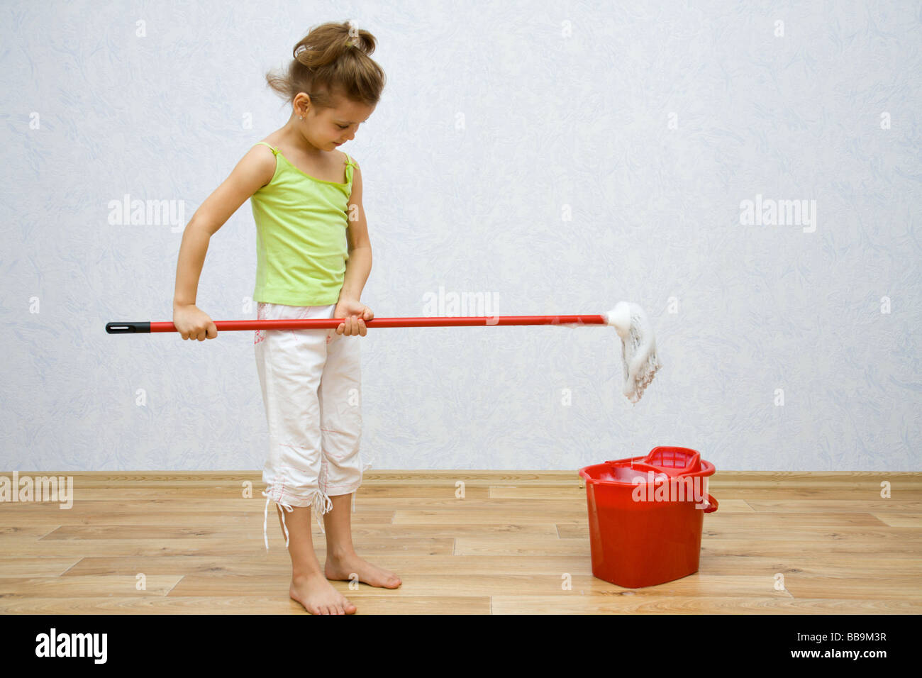 Girl sweeping the floor hi-res stock photography and images - Alamy