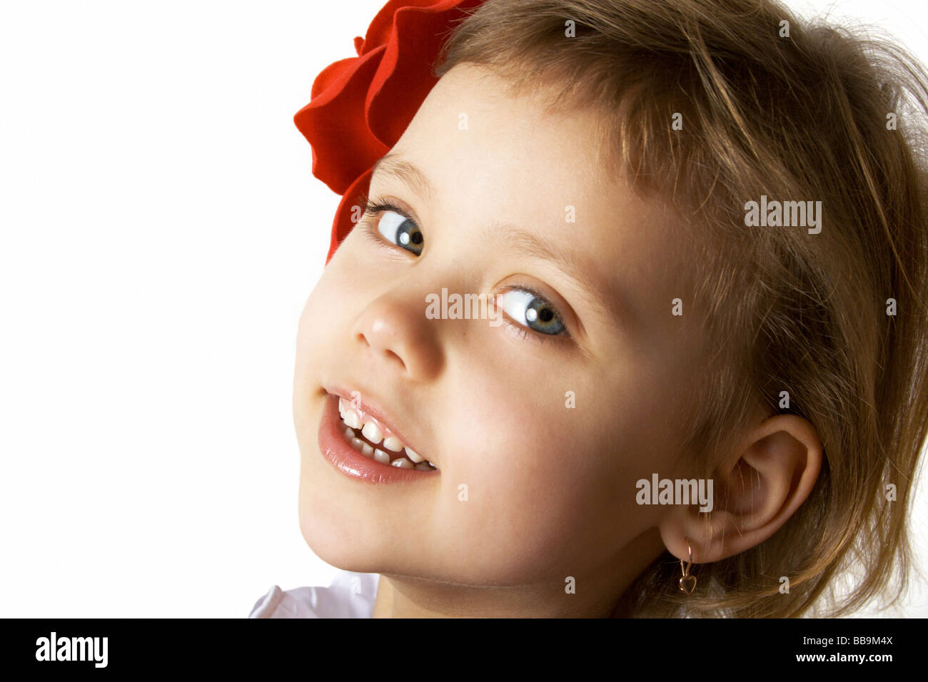 Little girl with red rouses in the hair Stock Photo - Alamy