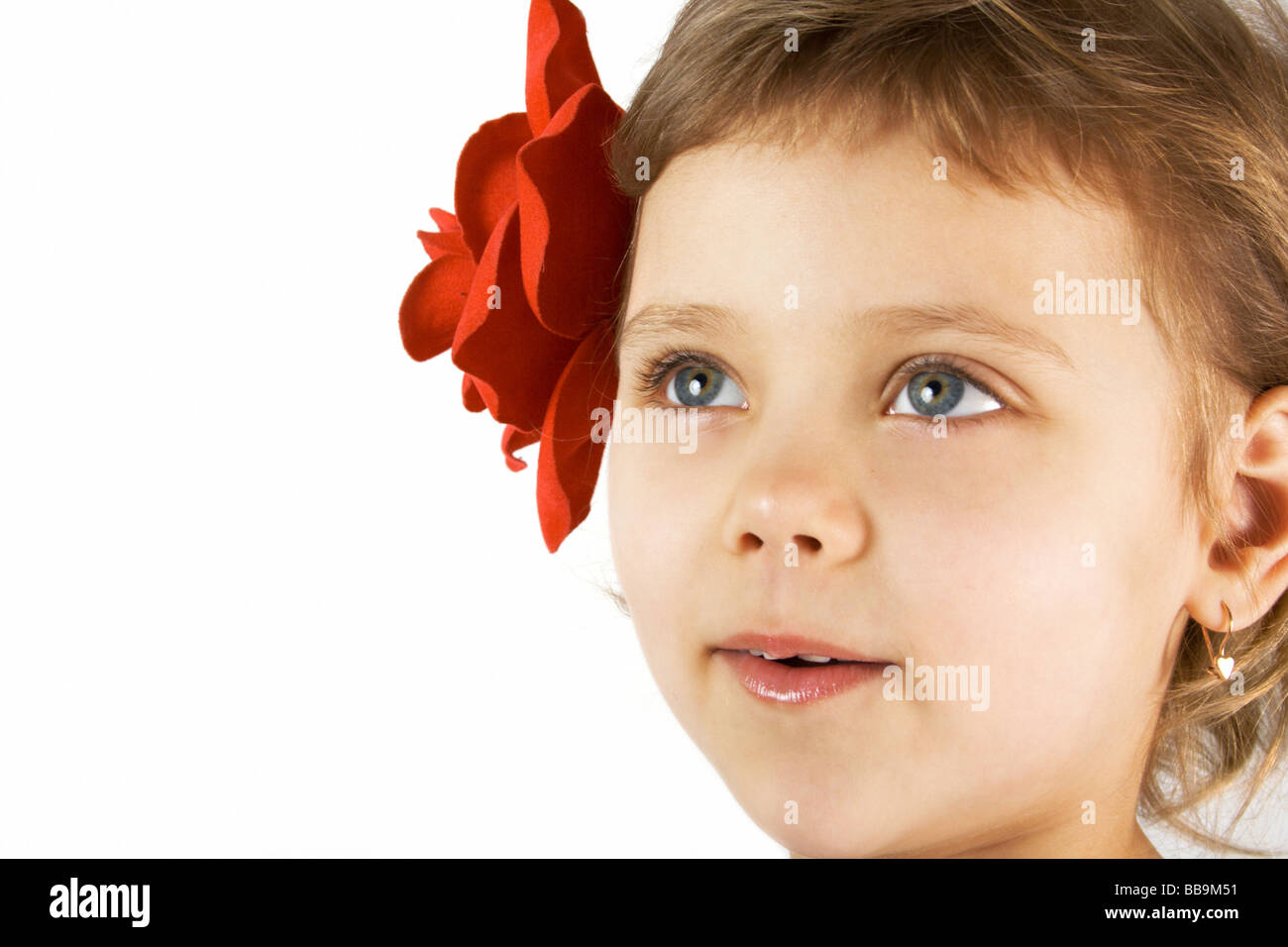 Little girl with red rouses in the hair Stock Photo - Alamy
