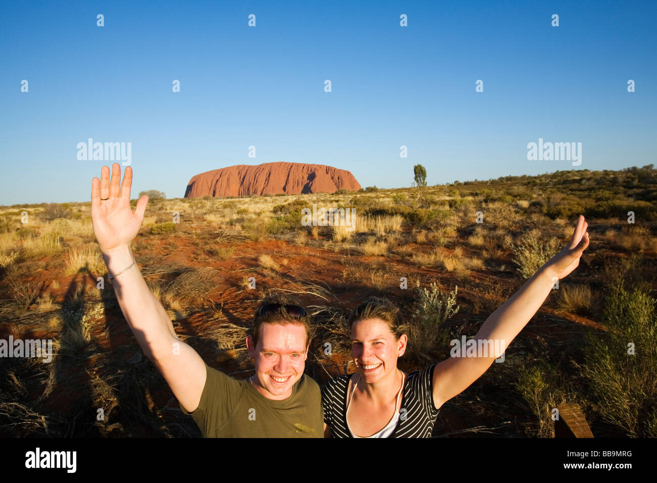 Holiday couple at Uluru (Ayers Rock). Uluru-Kata Tjuta National Park ...