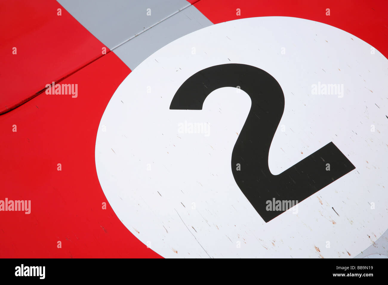 Number 2 in white circle on red background Stock Photo - Alamy
