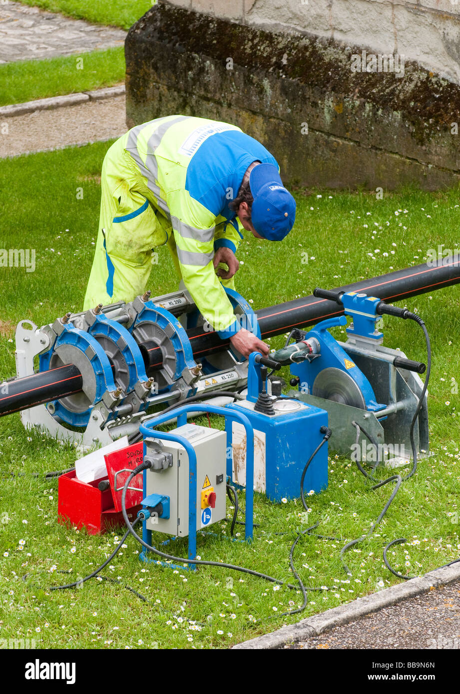 Contractor operating heat-weld flexible conduit machine - France Stock ...