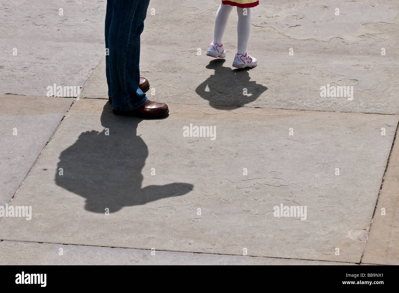 An adult and a child casting a shadow. Photo by Gordon Scammell Stock ...