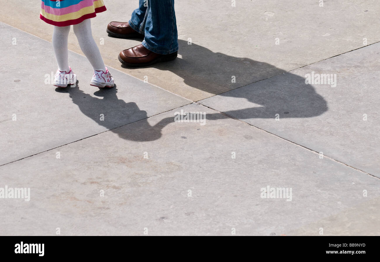 An adult and a child casting a shadow. Photo by Gordon Scammell Stock ...