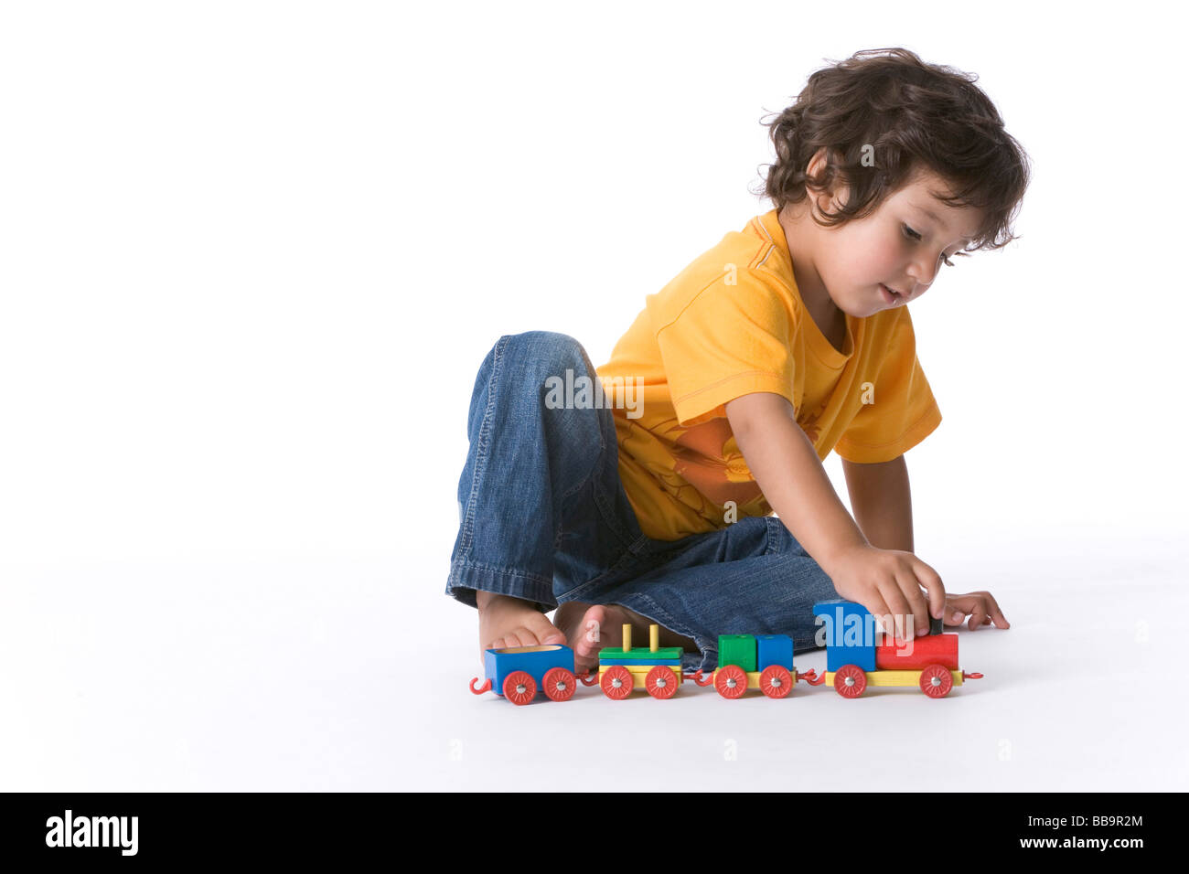 Little boy playing with a wooden train Stock Photo - Alamy
