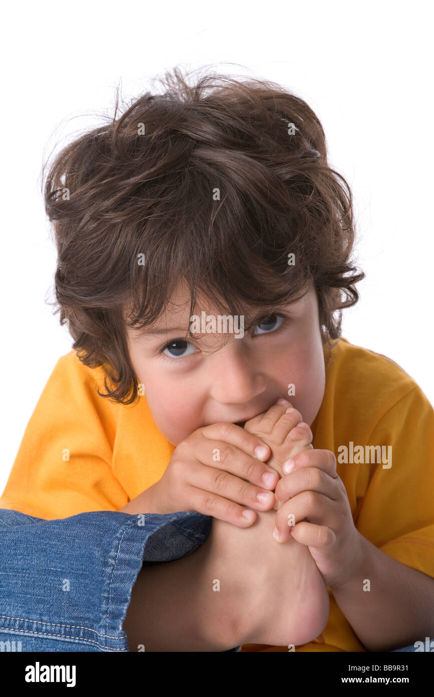 Little boy eating his large toe as a joke Stock Photo - Alamy