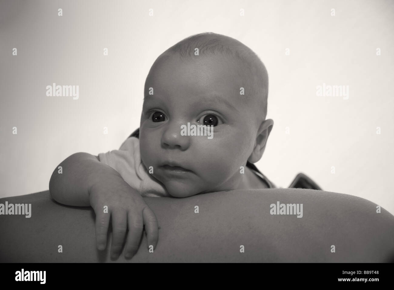 A young newborn baby boy looking intently Stock Photo - Alamy