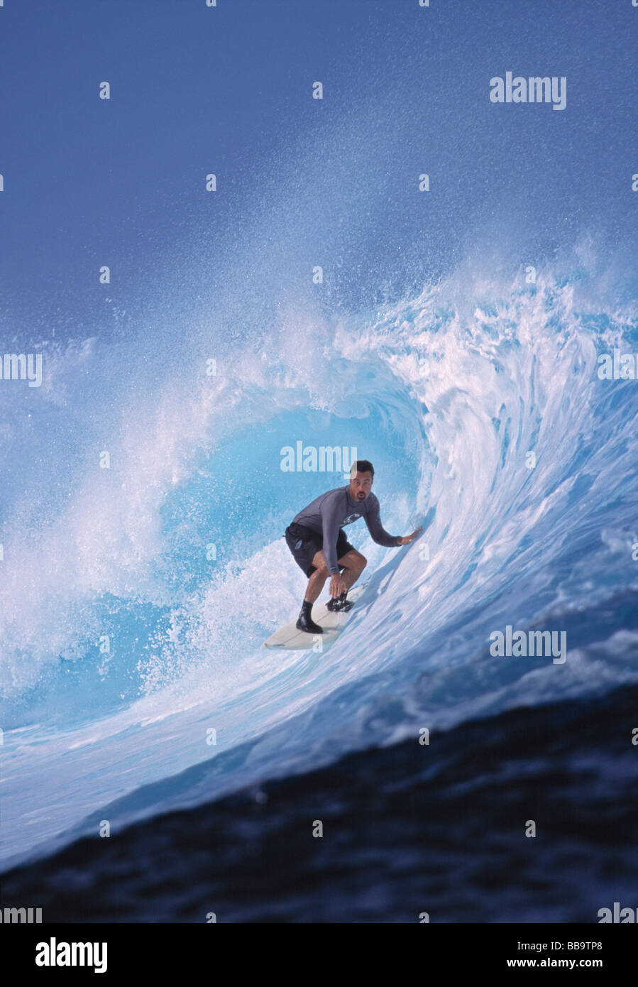 A surfer rides the tube at Cloudbreak Tavarua Fiji Islands Stock Photo ...