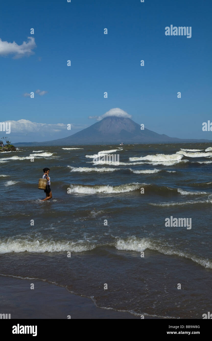 A Nicaraguan woman carries a bucket to fill water from Lake Cocibolca ...