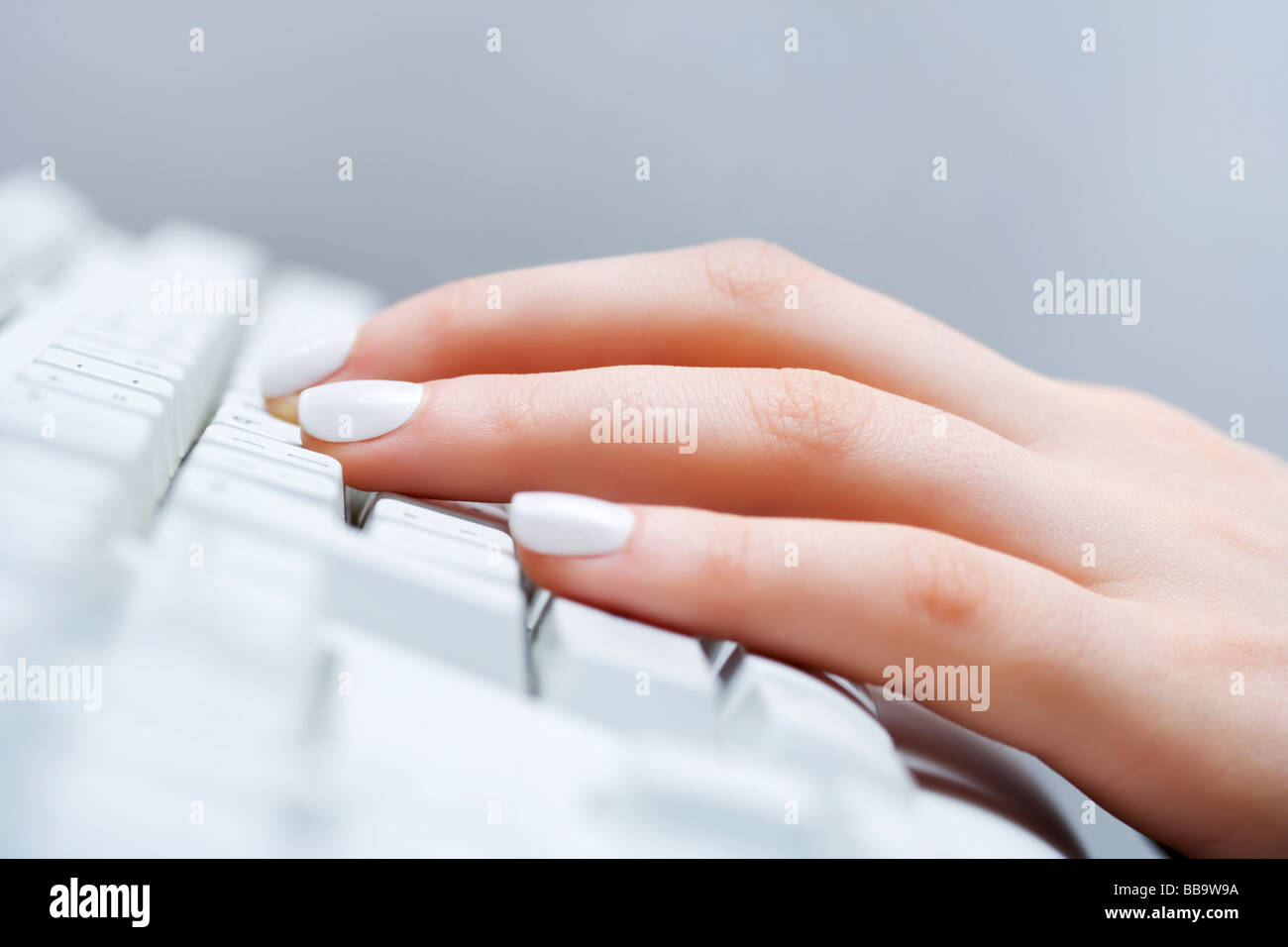 Female hand typing on keyboard Stock Photo - Alamy