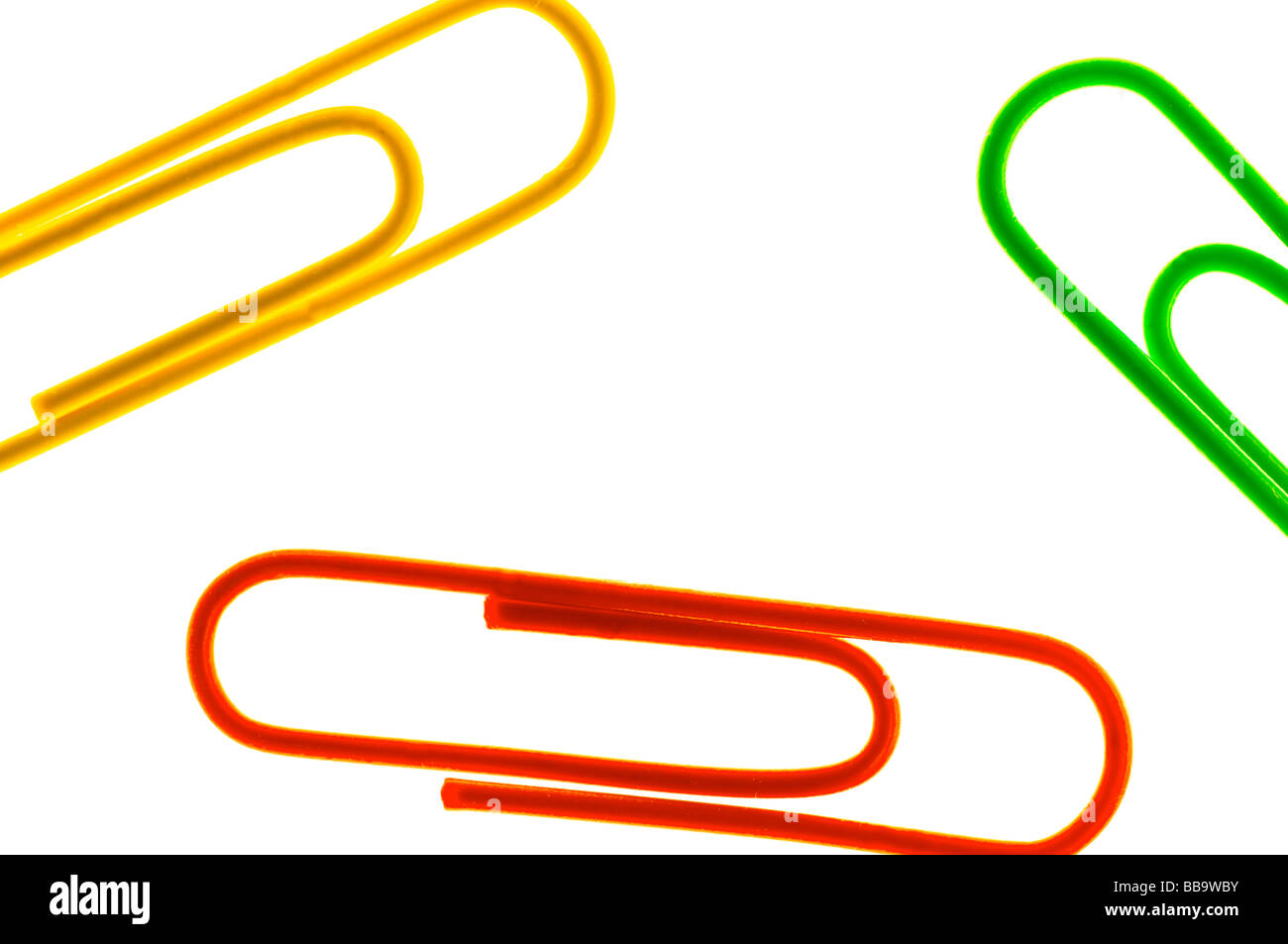 Red yellow and green paper clips on white background Stock Photo - Alamy