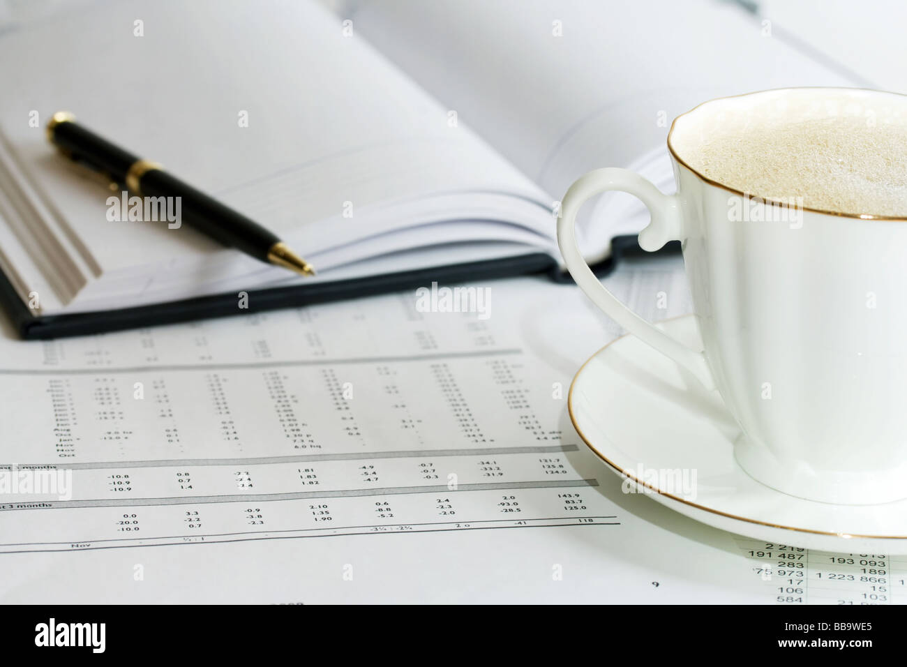 Cup of coffee and financial accounting Stock Photo - Alamy