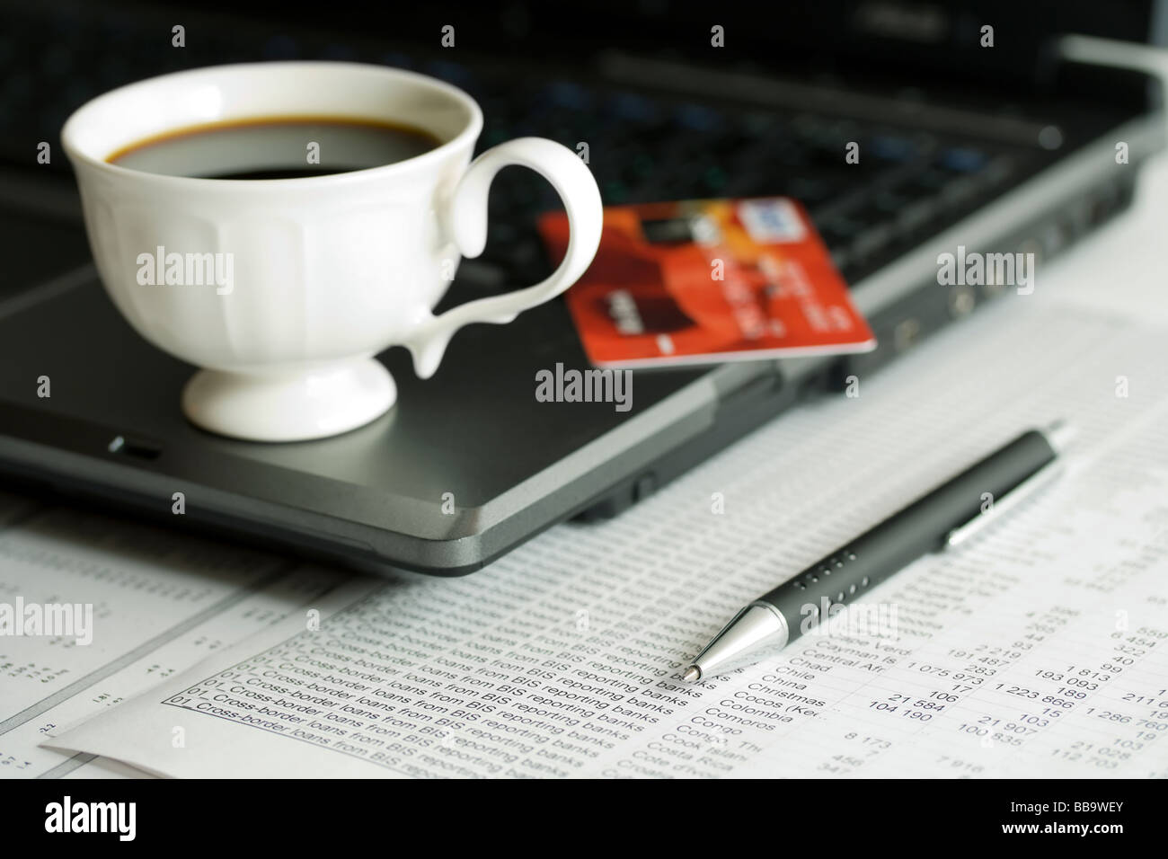 Cup of coffee and financial accounting Stock Photo - Alamy