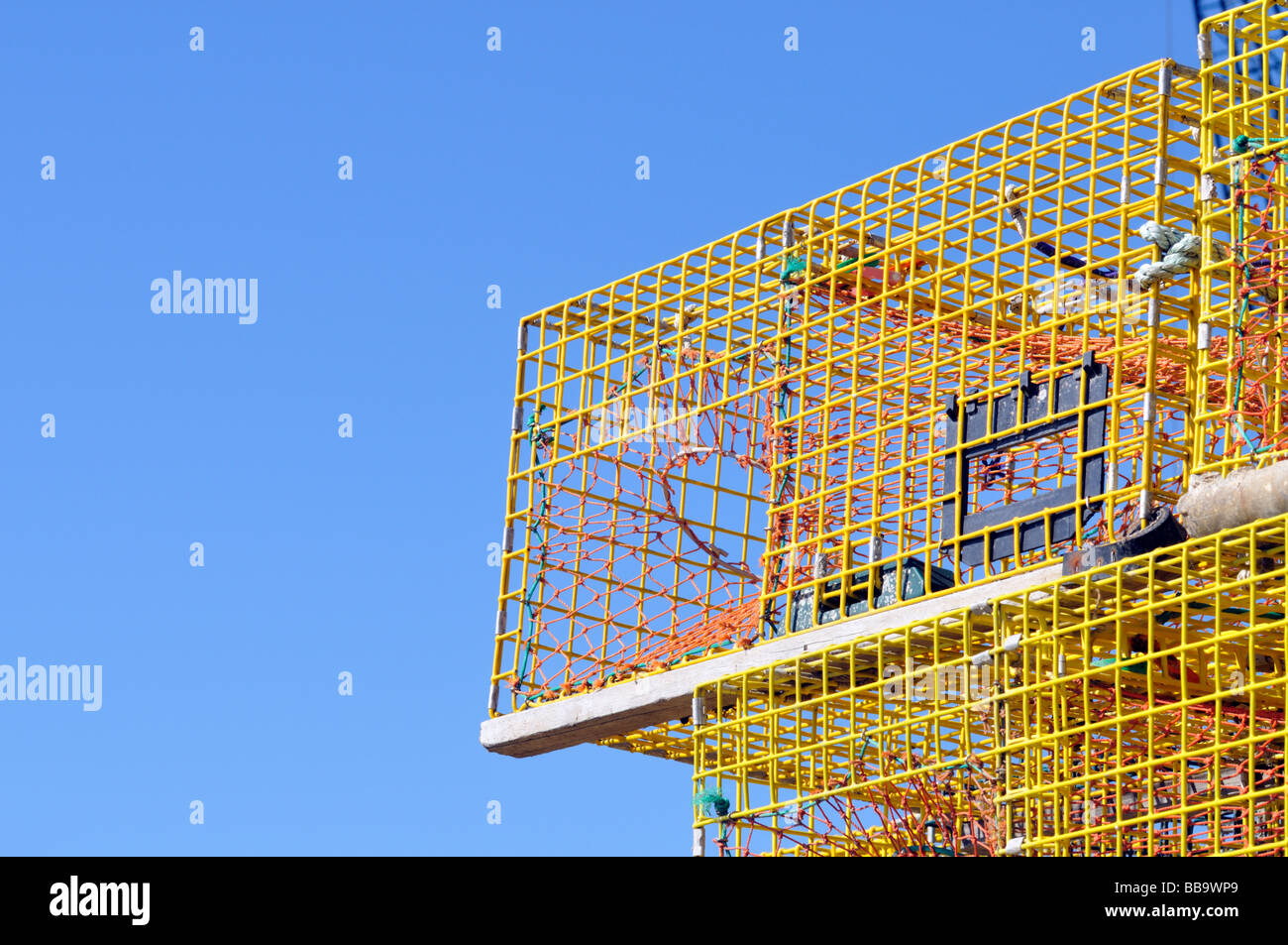 New yellow wire lobster traps against blue sky Stock Photo - Alamy