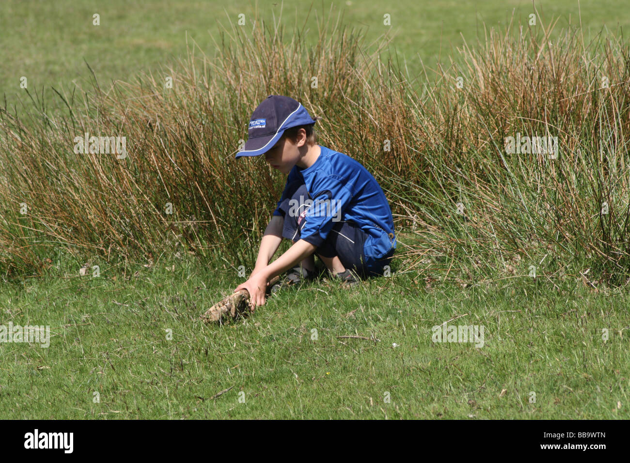 Boy playing with stick Stock Photo - Alamy