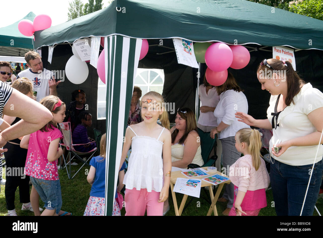 A young girl enjoys having her face painted, Wallingford town fair ...