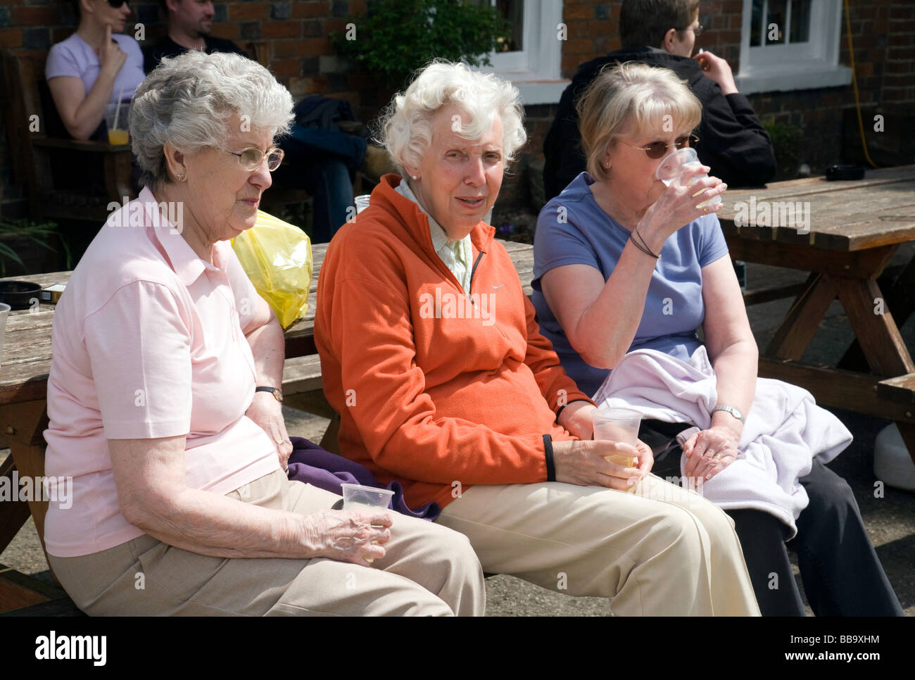 Three elderly ladies drinking outside a pub on a summers day, The Coach ...