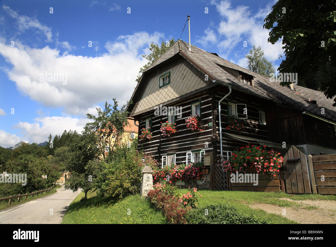 Traditional Austrian farm house in summer with flowering window boxes ...