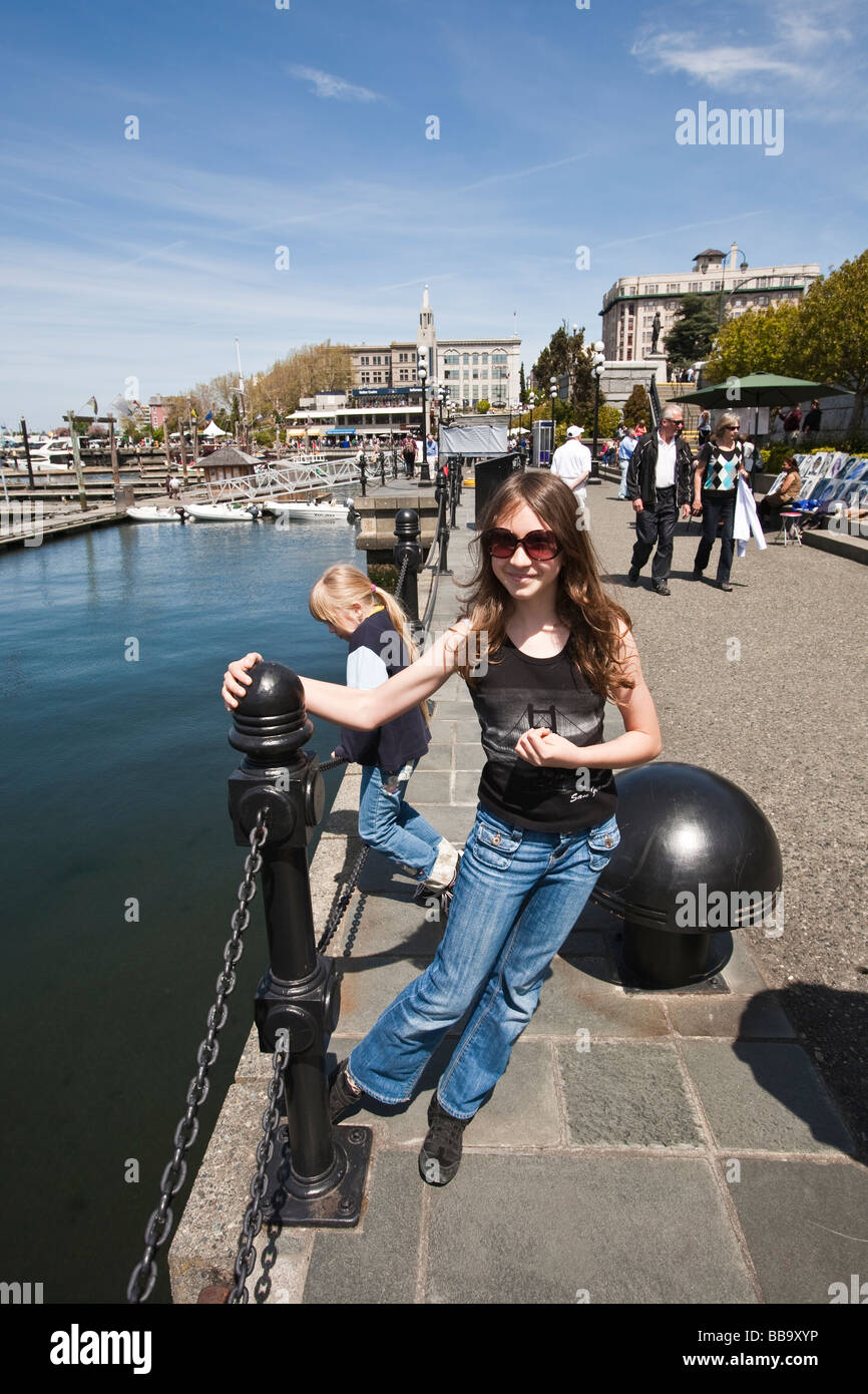 Girl playing on a sidewalk in the Inner Harbour Victoria Day in ...