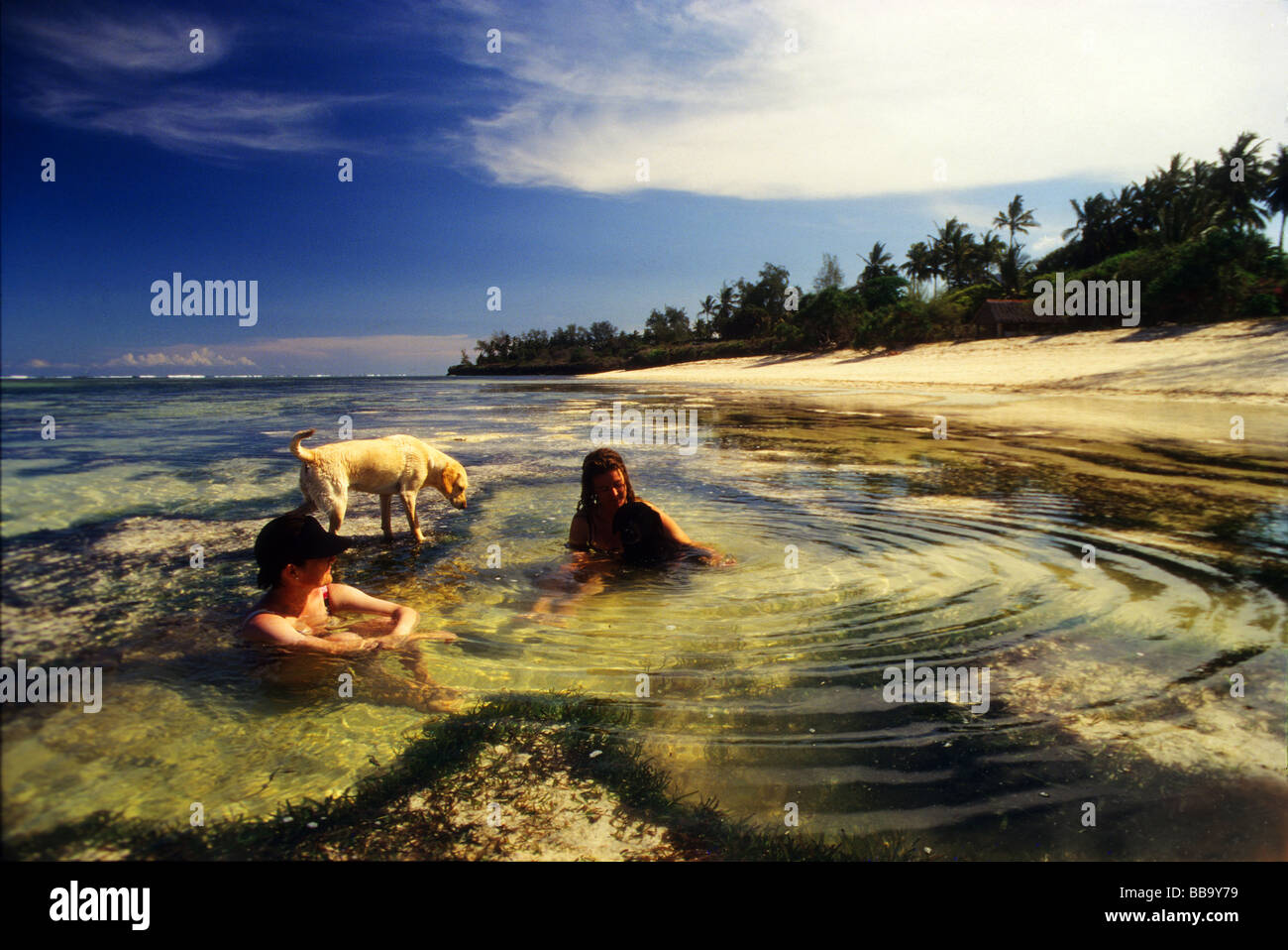 Tourists relaxing in shallow water in Tiwi Beach, Kenya Stock Photo - Alamy