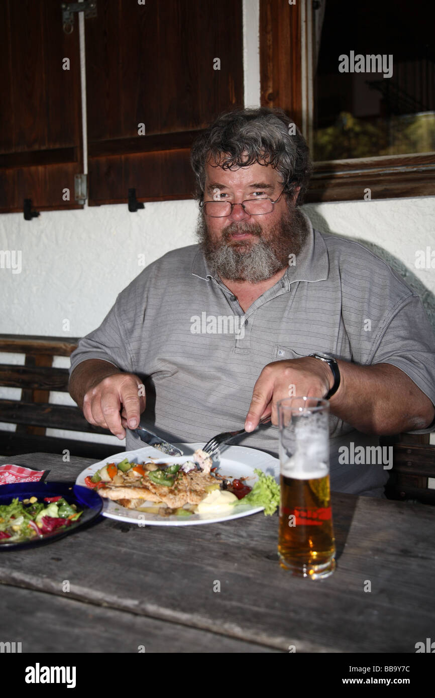 Large man eating in restaurant Stock Photo - Alamy