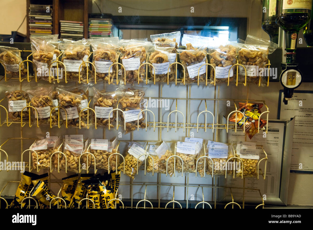 Pork Scratchings, Roasted peanuts and cashews for sale behind the bar ...