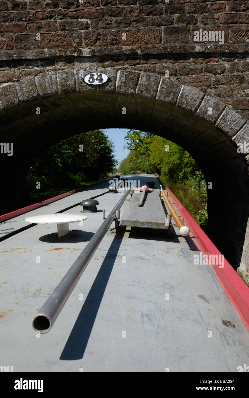 A narrow boat passing under a bridge, Shropshire Union Canal, England ...