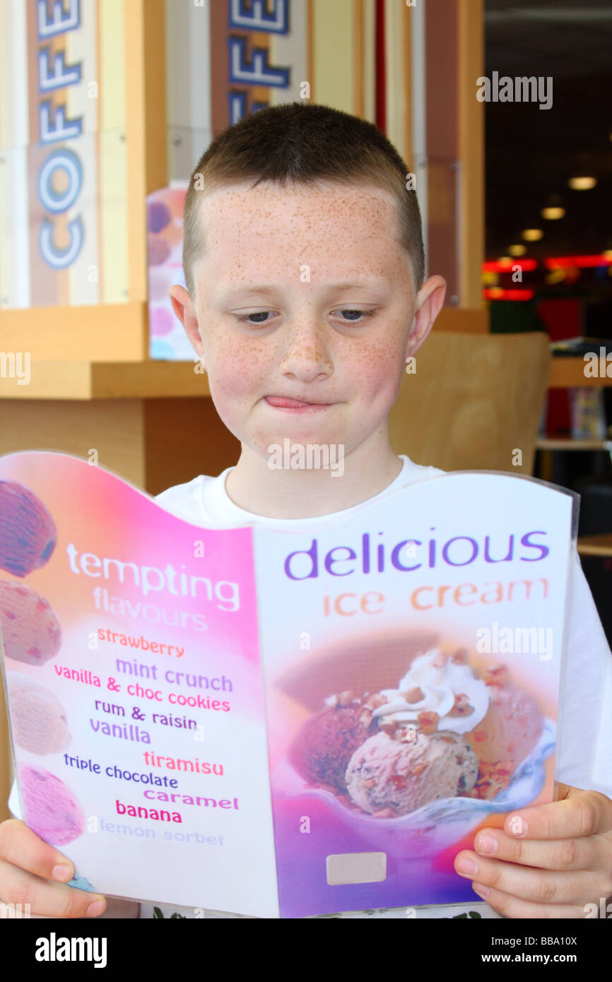 Young boy choosing ice cream from a menu Stock Photo - Alamy