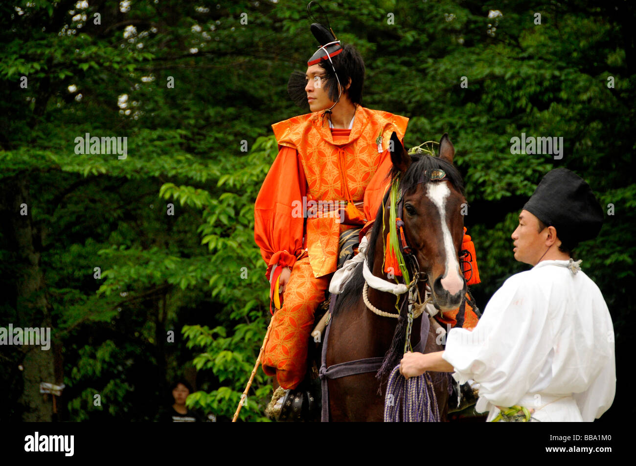Rider in the historical costume of the Heian period with groom ...
