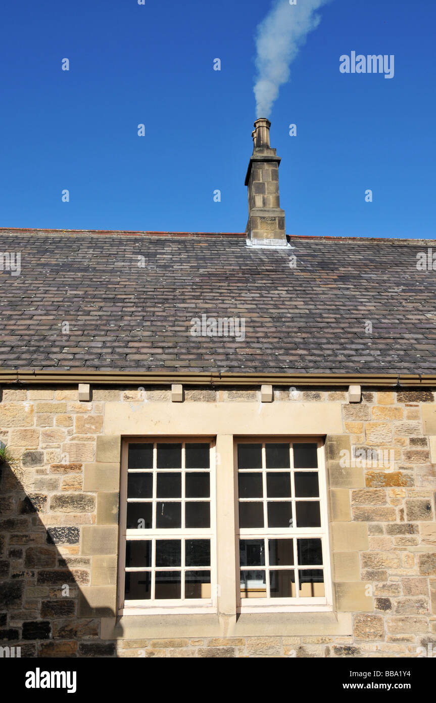 Ancient chimney on tiled roof with blue sky background Stock Photo - Alamy