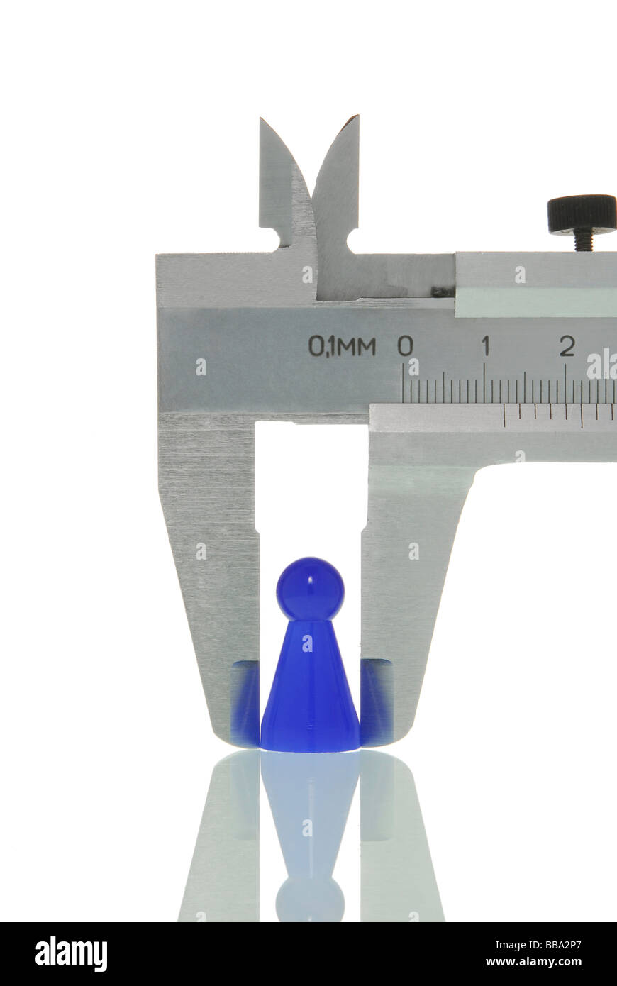 Calipers with a game piece, symbolic image for analysis of a human ...