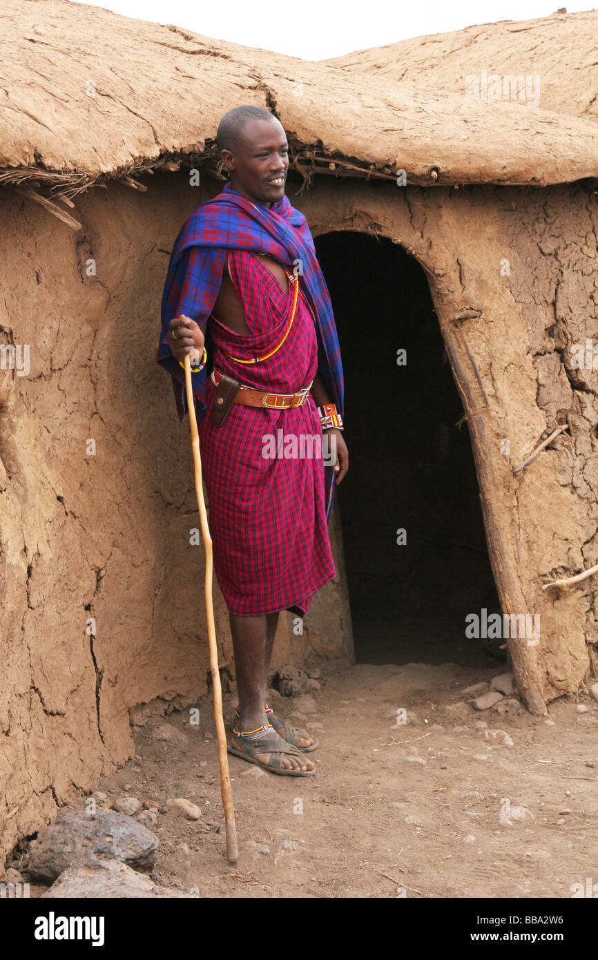 A Masai man standing by the door to his mud and straw home Amboseli ...