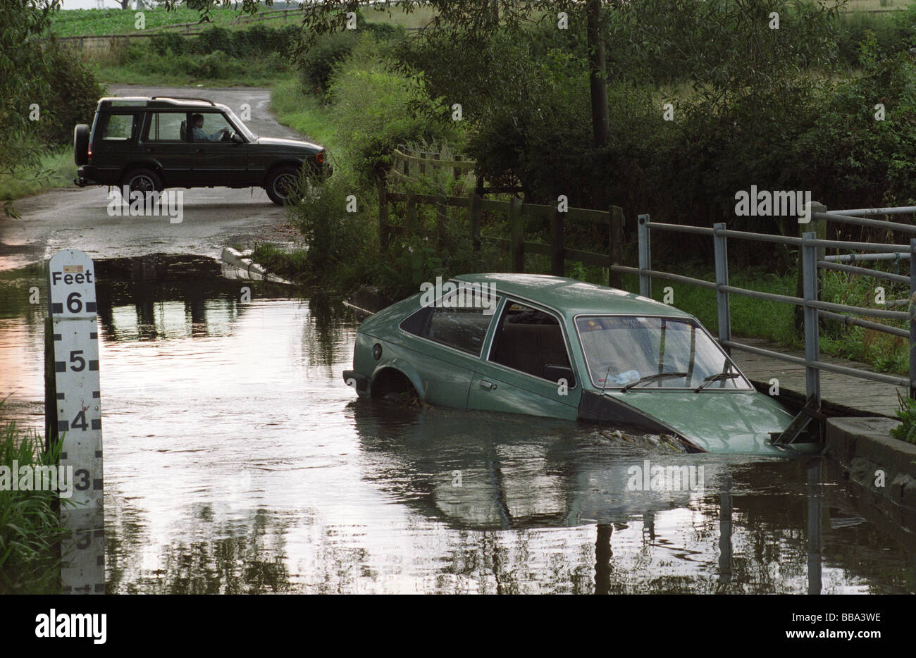 Car stuck in flooded ford at Trescott on Furnace Grange Rd near ...
