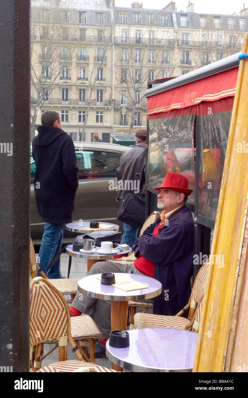 Man with red hat in cafe at Place St Michel Paris Stock Photo - Alamy