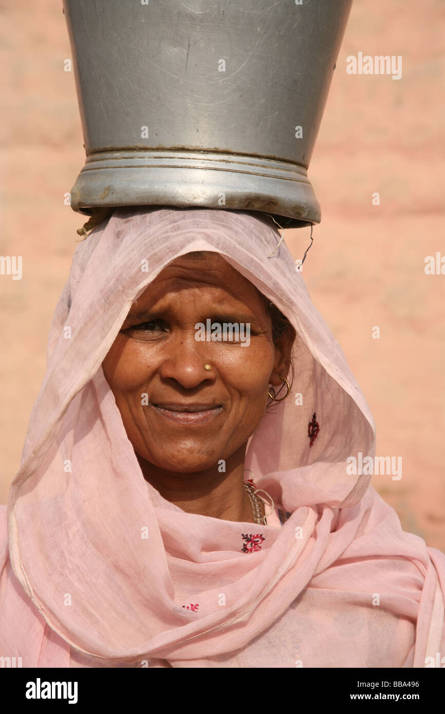 Indian lady carrying a bucket of water on her head, New Delhi, India ...