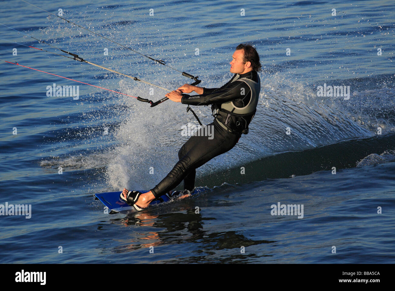 Kite Surfing. Kite Surfer creating huge wake as they move quickly atop ...