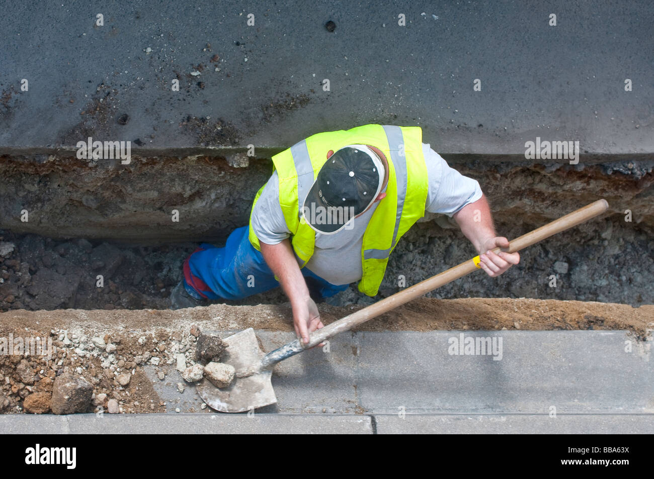 Road works contractor digging in excavated trench - France Stock Photo ...