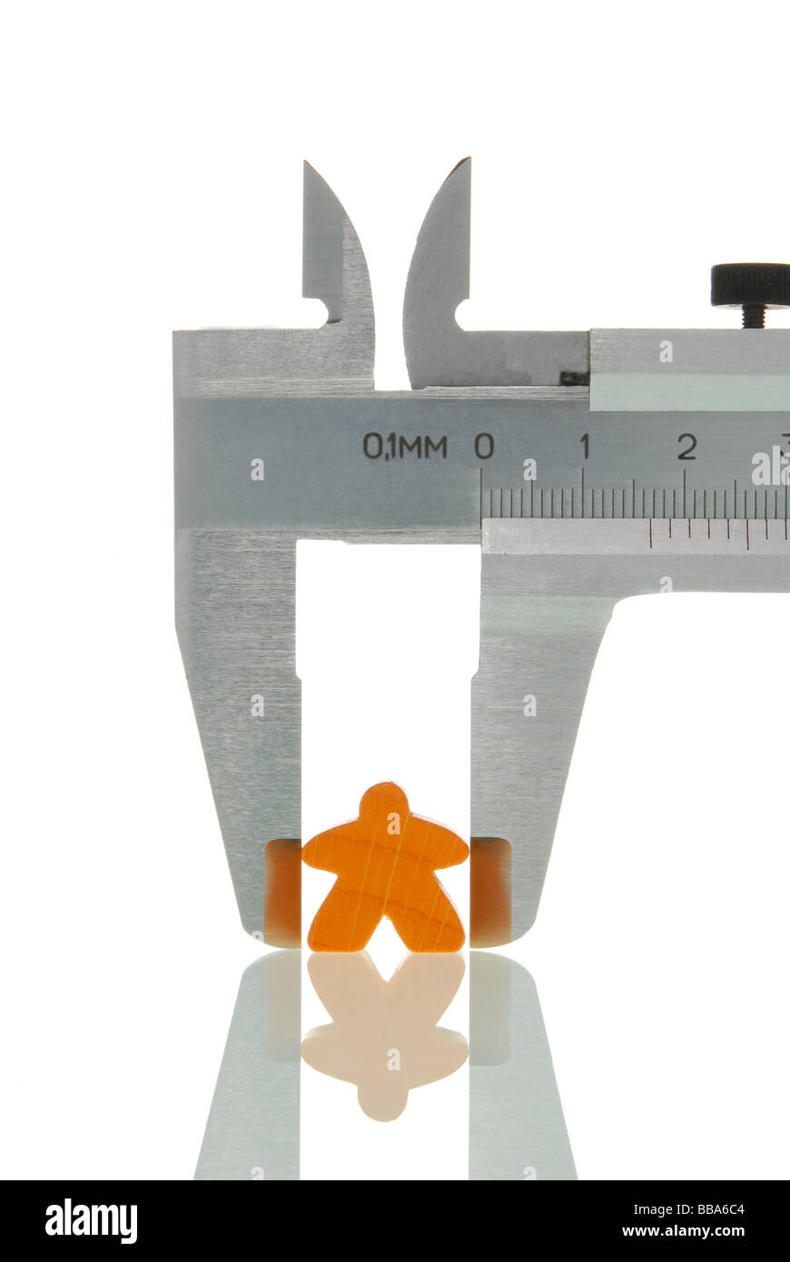 Calipers with a game piece, symbolic image for analysis of a human ...